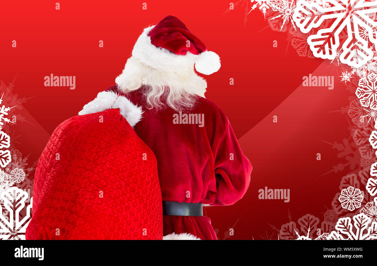 Santa claus carrying sack against christmas themed snow flake frame Stock Photo - Alamy