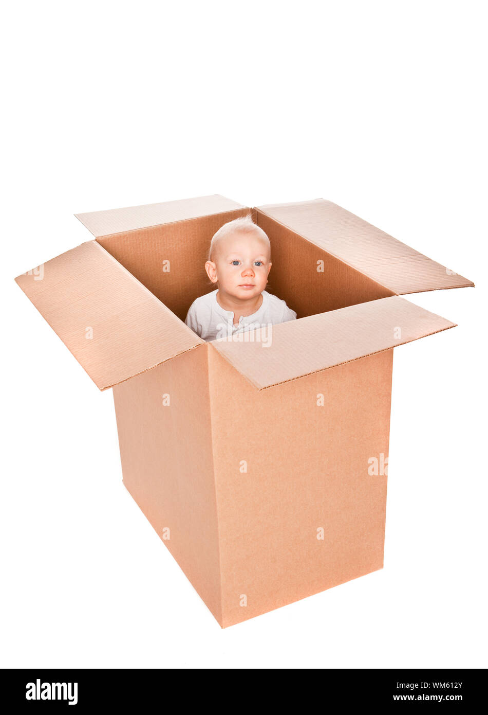 Baby boy in a box isolated against a white background Stock Photo - Alamy