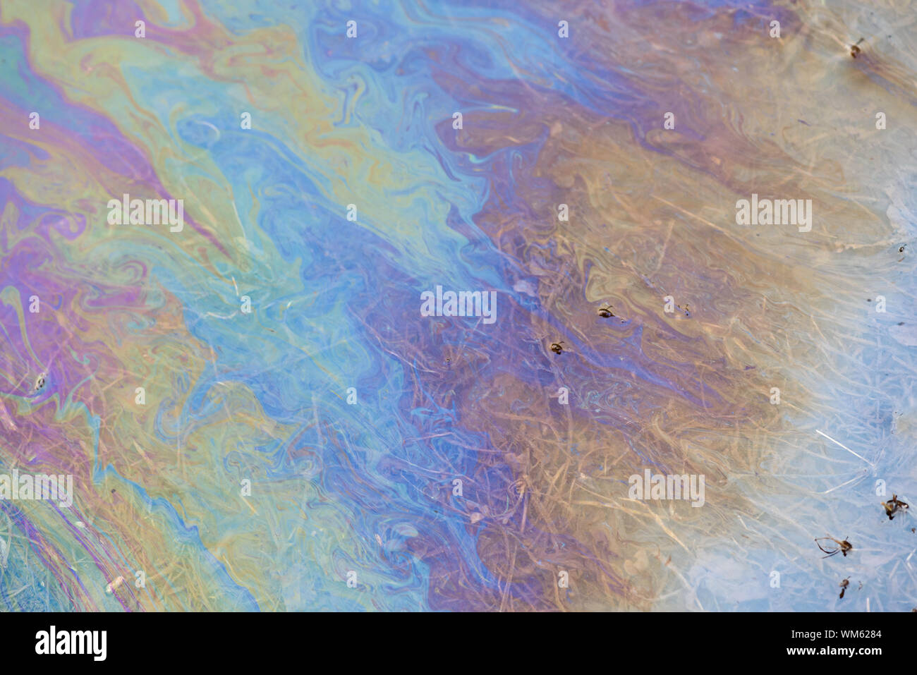 Toxic colours of oil and water in a chemical spill creating a ...