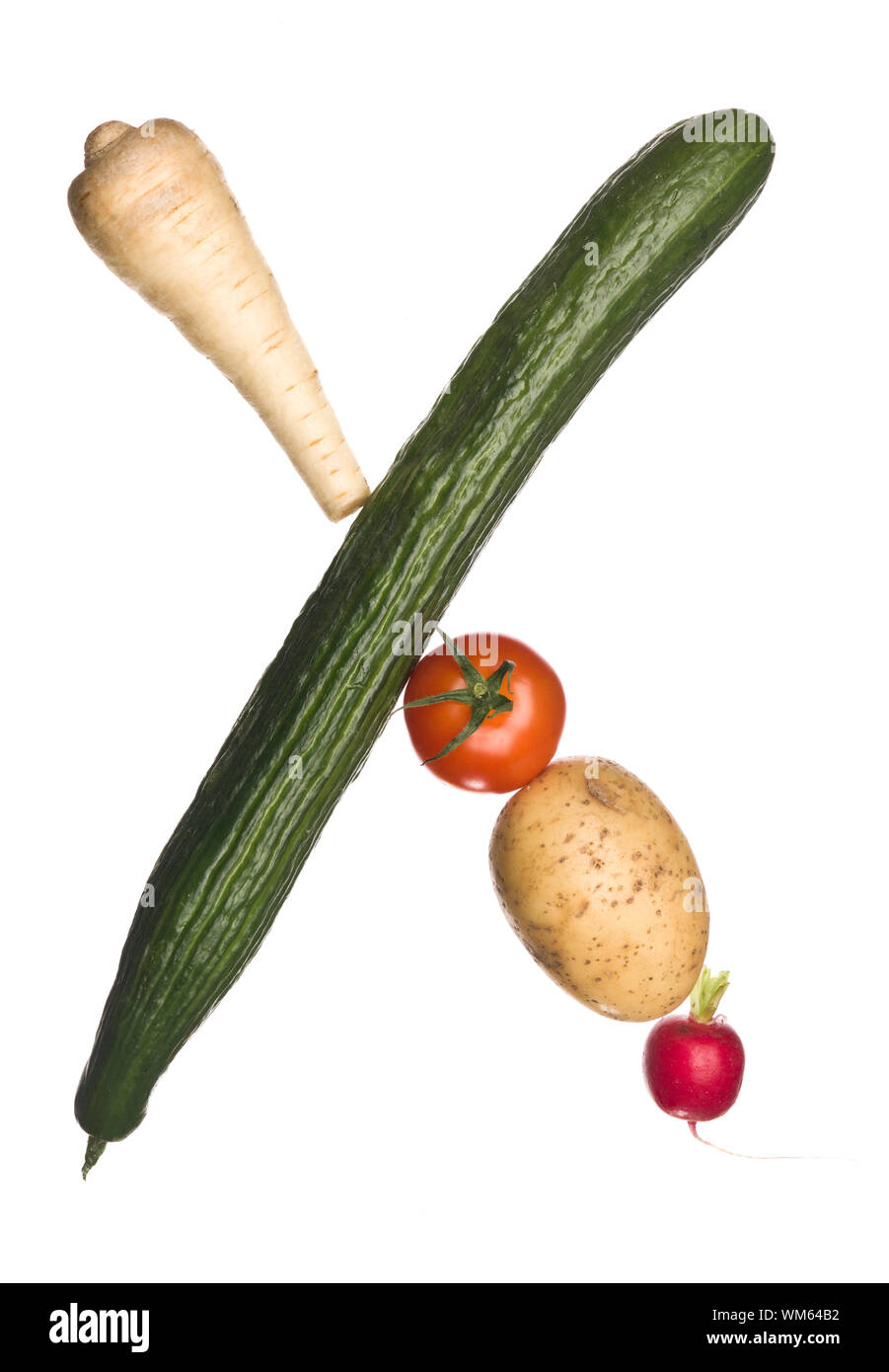 The letter 'X' made out of vegetables isolated on a white background ...