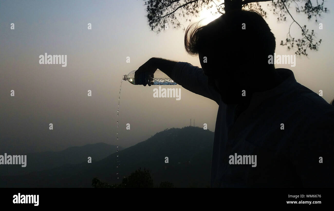 Person pouring water from bottle hi-res stock photography and images ...