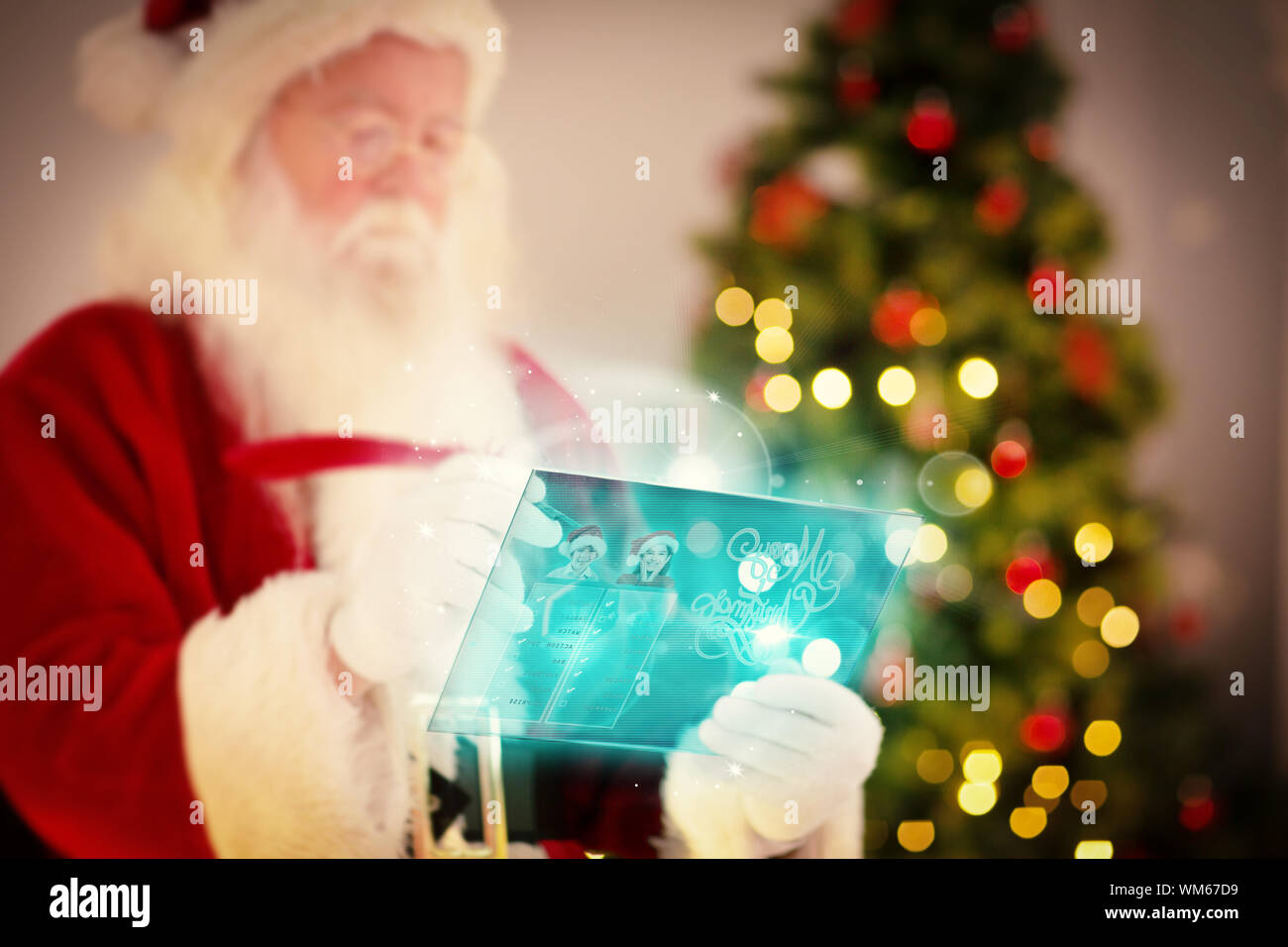 Composite image of santa checking his list Stock Photo - Alamy
