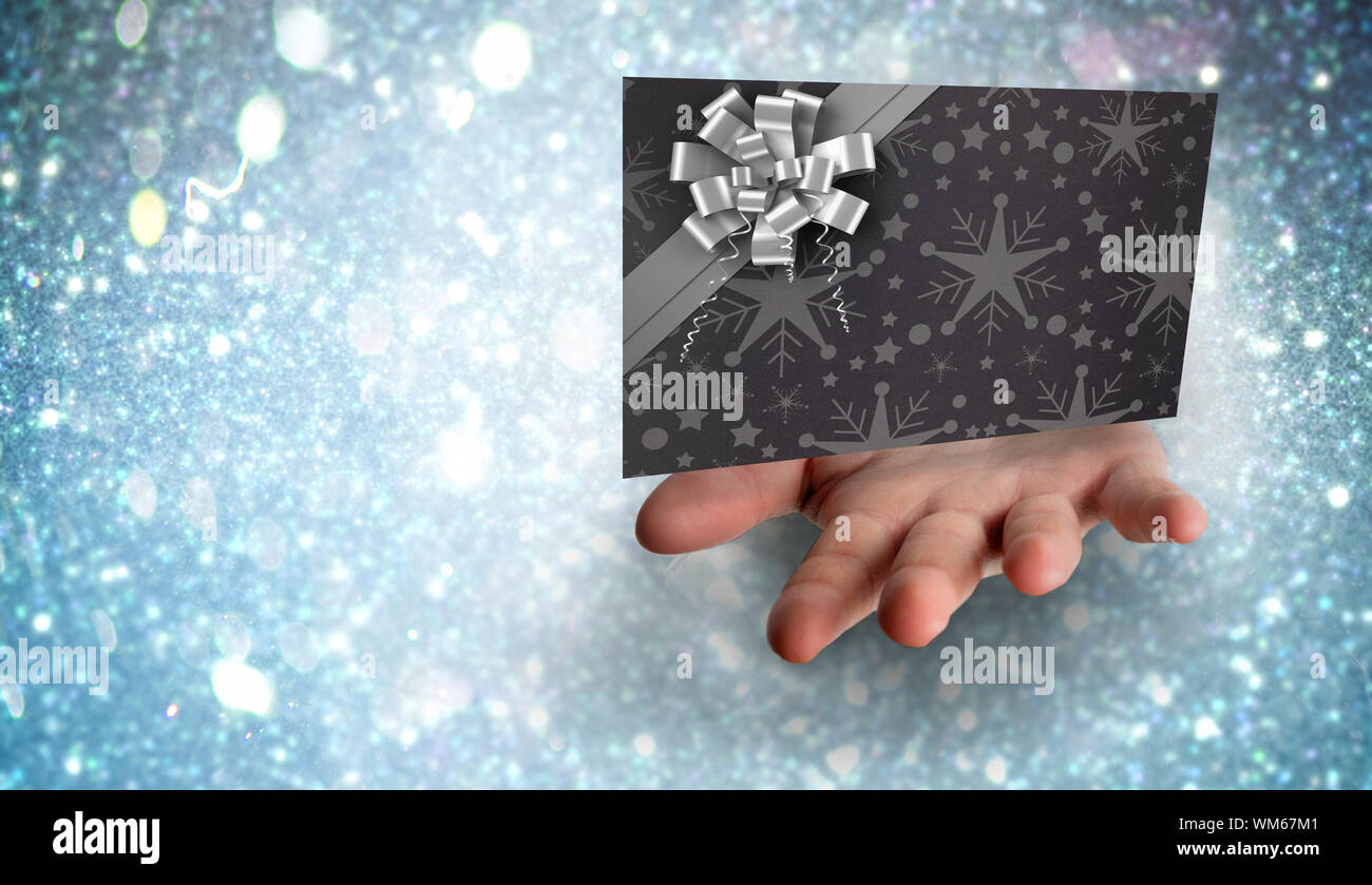 Hand bursting through paper against white snow and stars design Stock ...