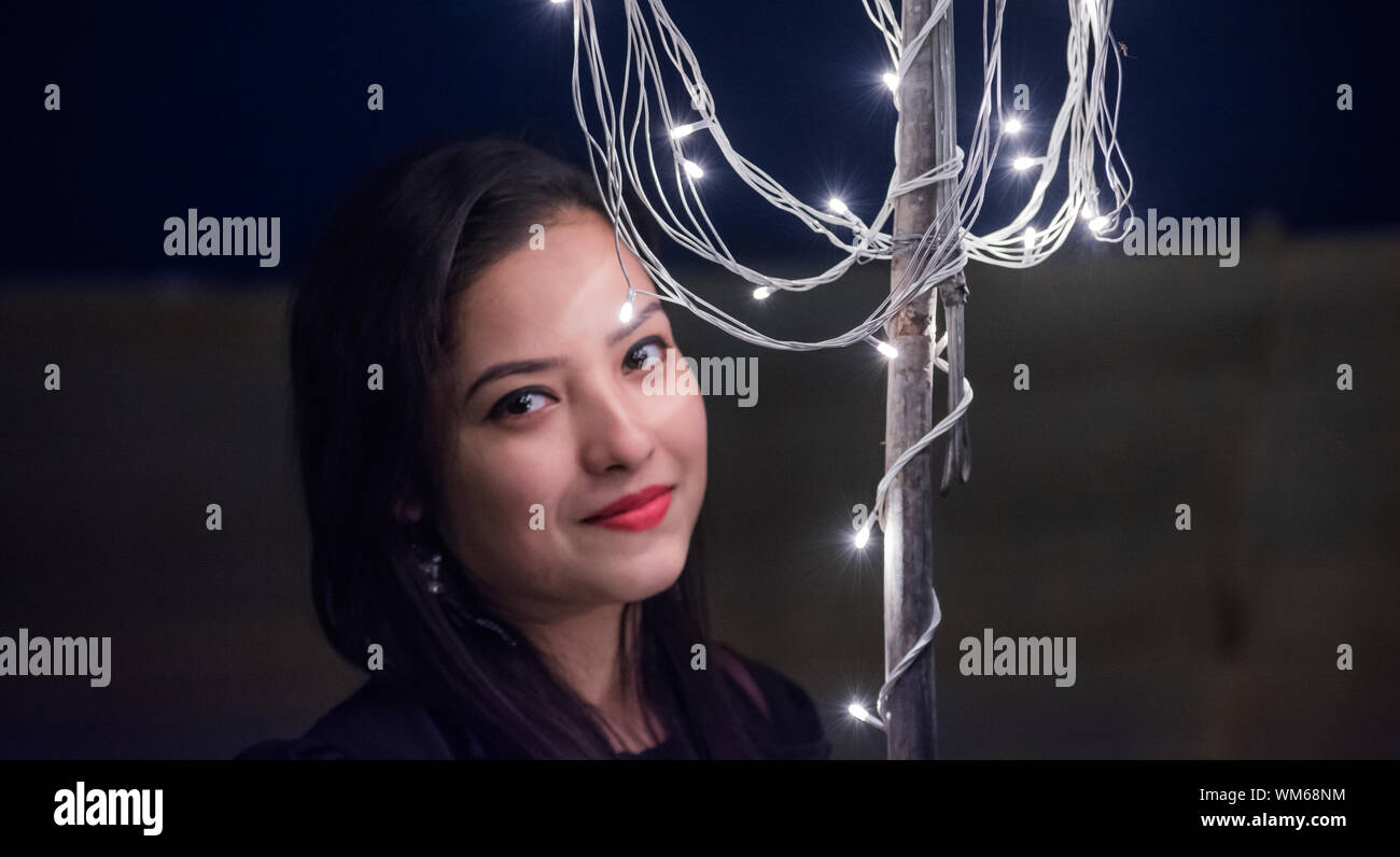 Woman hanging up lights hi-res stock photography and images - Alamy