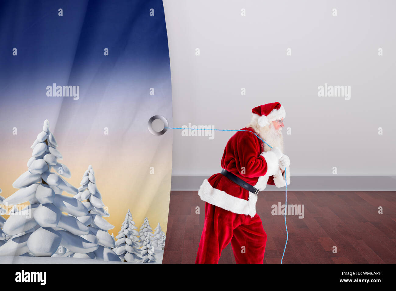Santa claus pulling rope against room with wooden floor Stock Photo - Alamy
