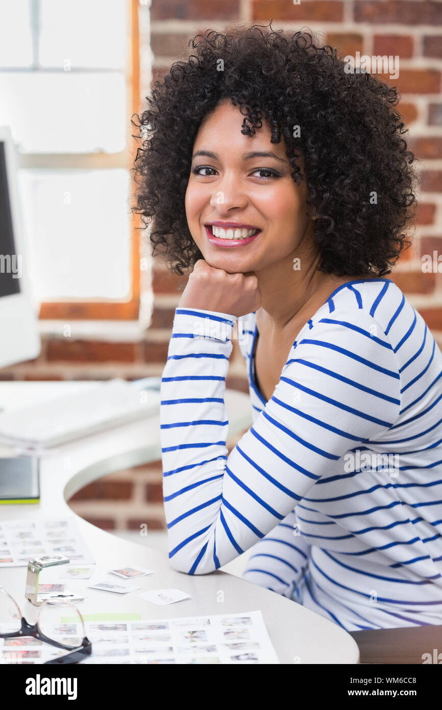 Portrait of smiling female photo editor using computer in the office ...