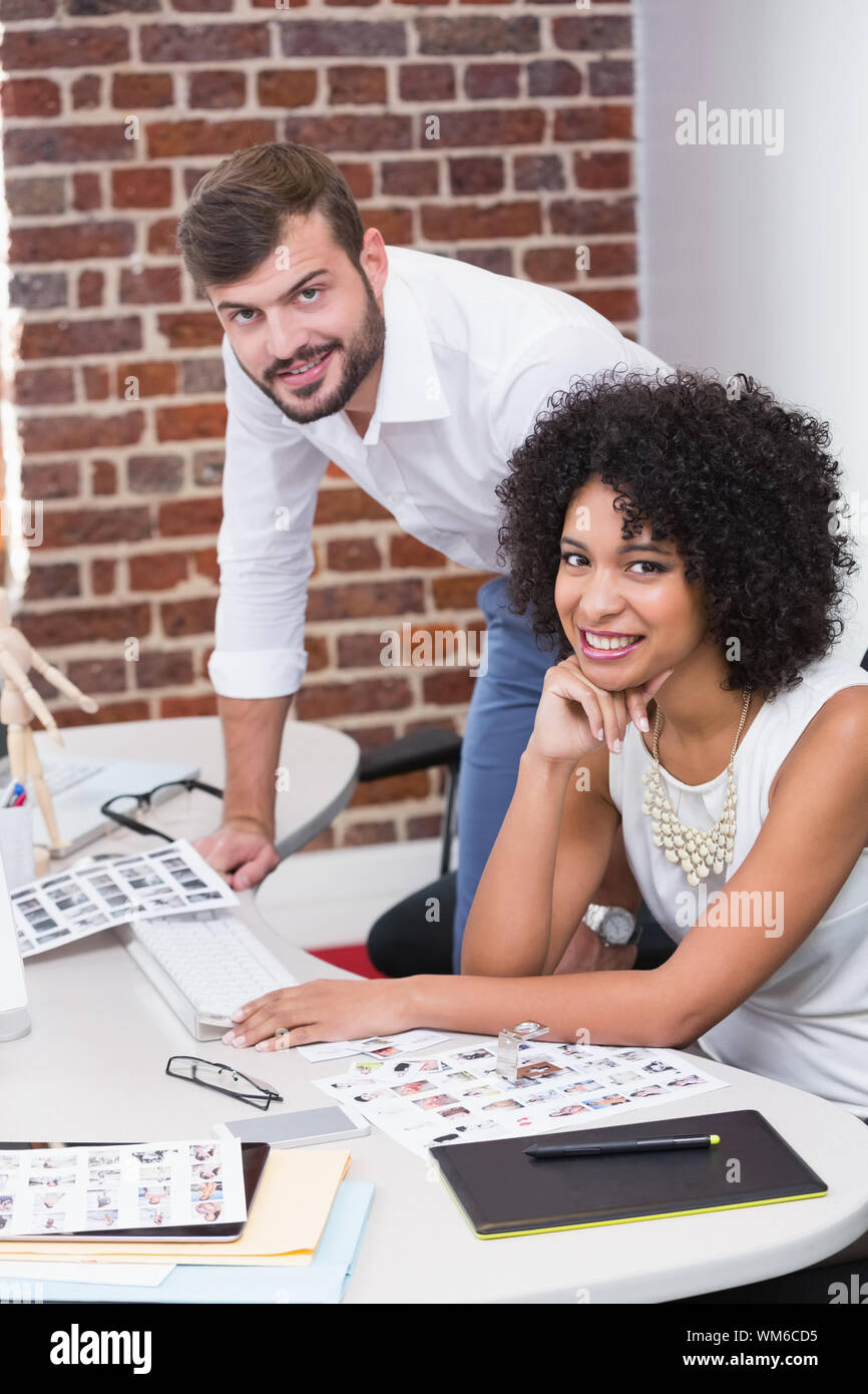 Portrait of smiling photo editors in the office Stock Photo - Alamy