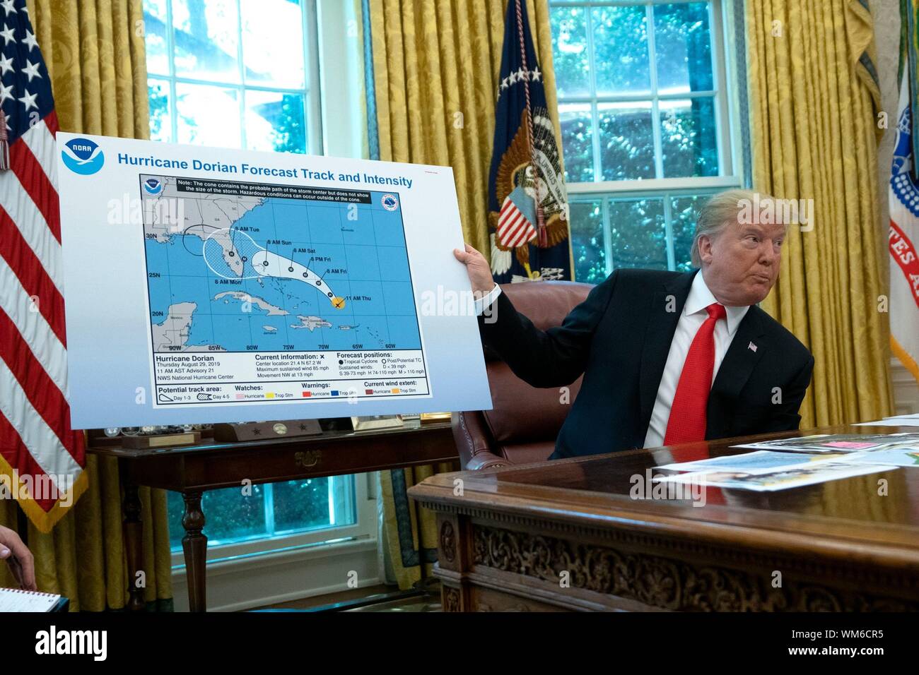 United States President Donald J. Trump holds a map that appears to ...