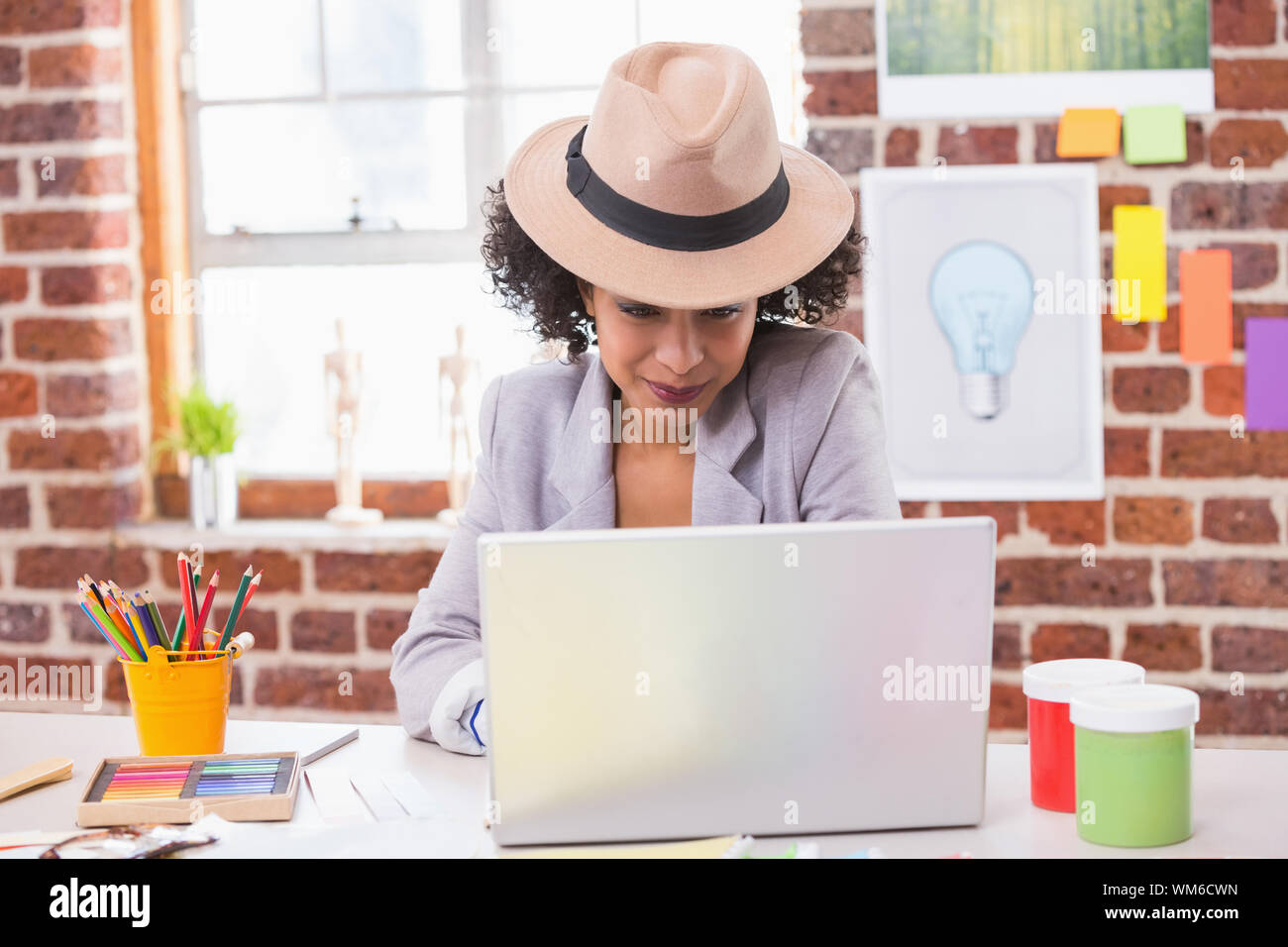 Concentrated female interior designer using laptop at office desk Stock ...