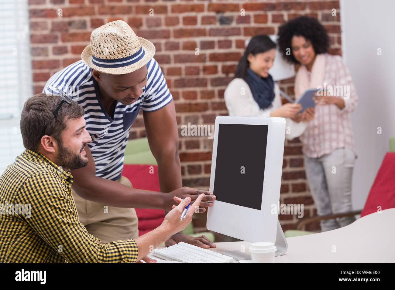 Casual business people using computer in the office Stock Photo - Alamy