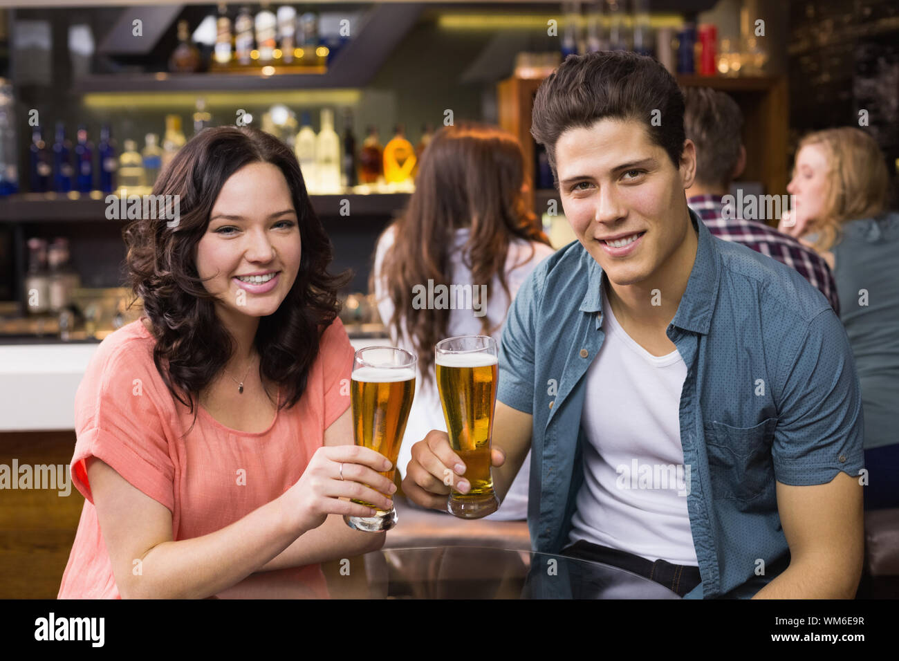 Young couple having a drink together at the bar Stock Photo - Alamy
