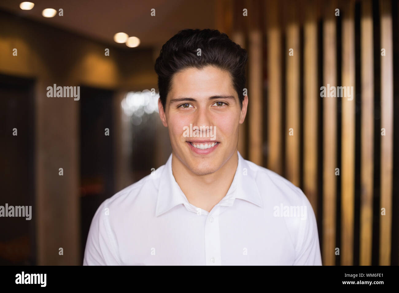Handsome man smiling at camera at the bar Stock Photo - Alamy