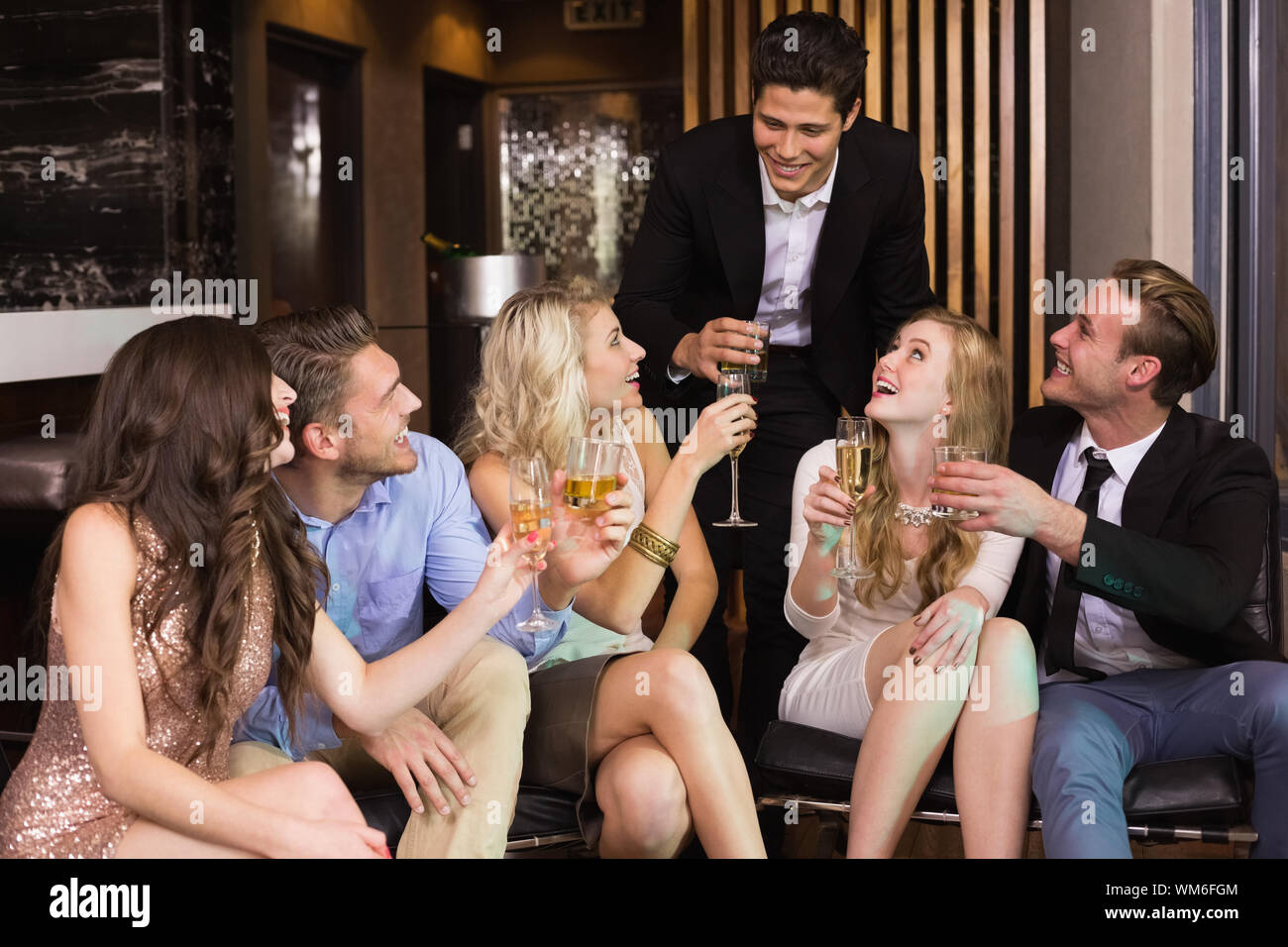 Stylish friends having a drink together at the bar Stock Photo - Alamy