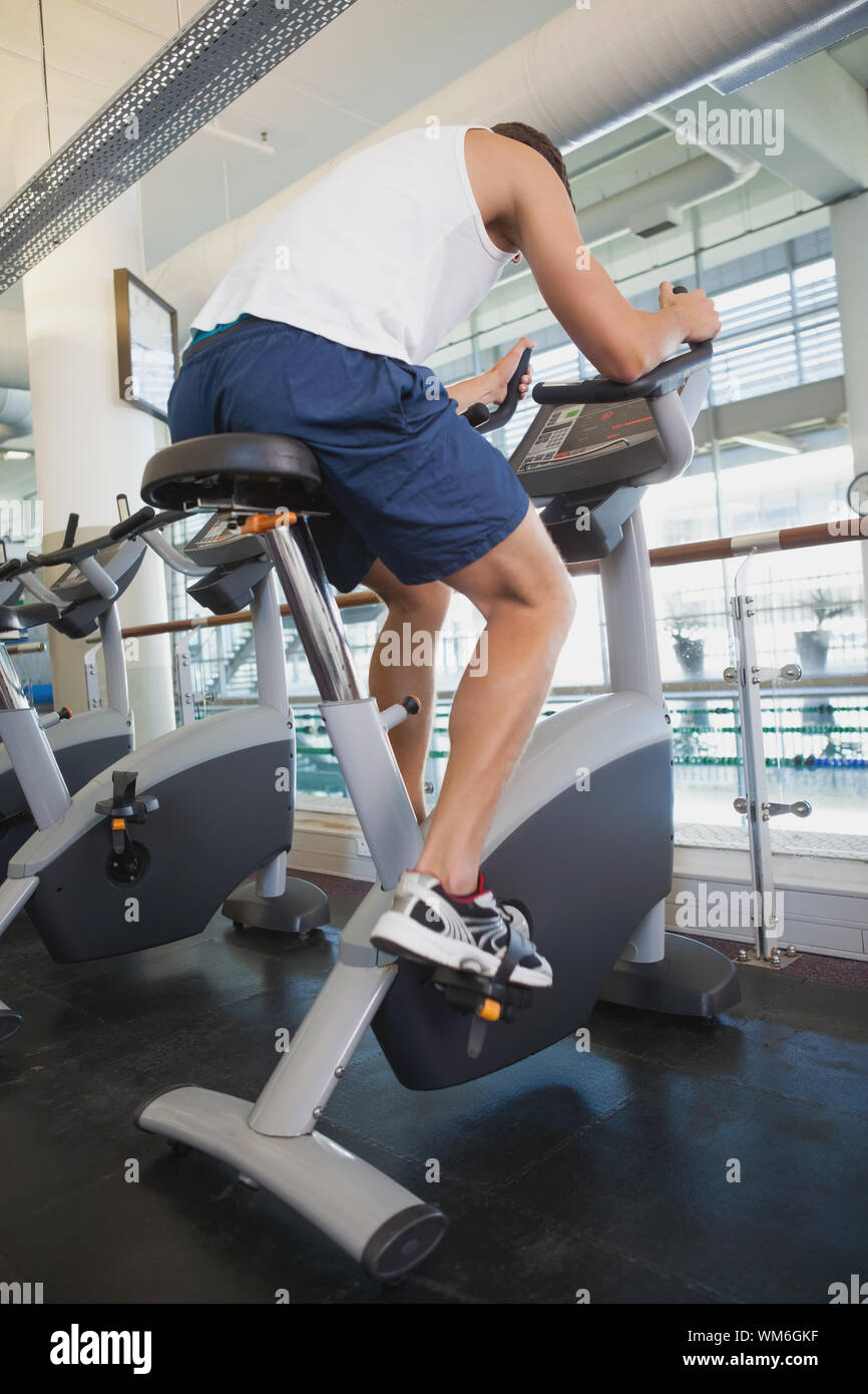 Fit man working out on the exercise bike at the gym Stock Photo - Alamy