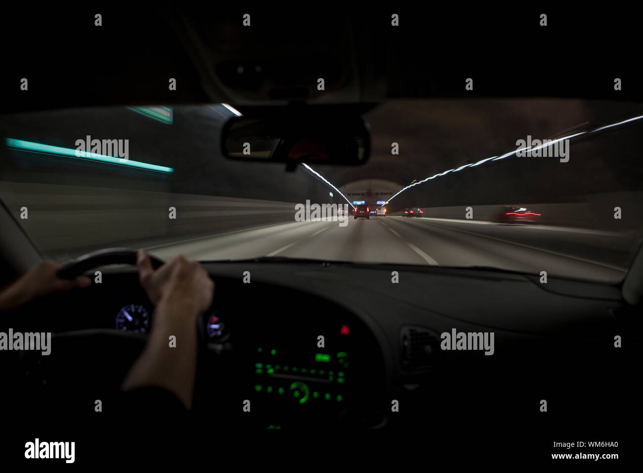 Man driving through a tunnel at night time Stock Photo - Alamy