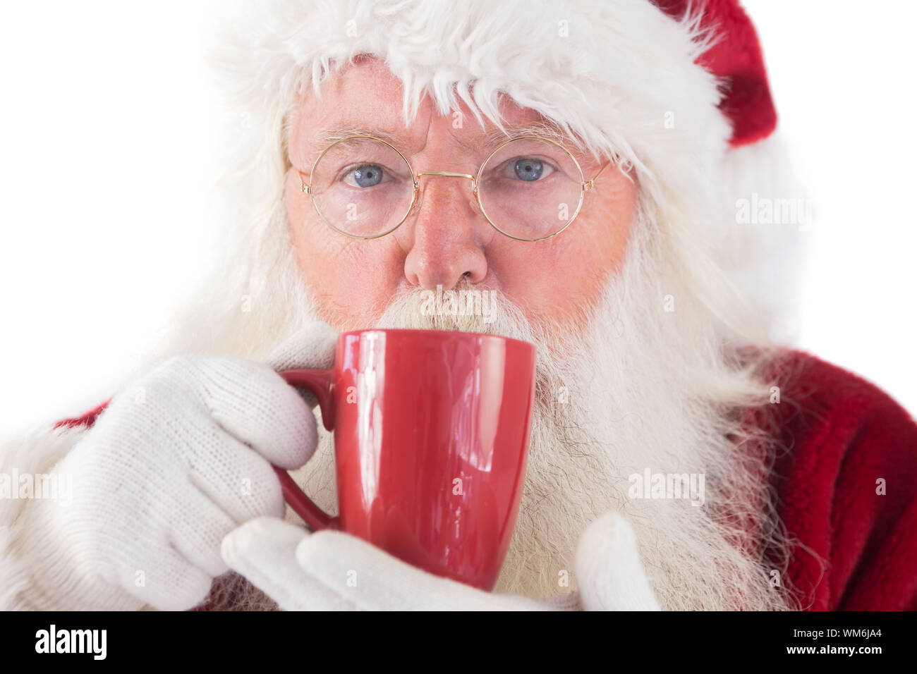 Santa drinks from a red cup on white background Stock Photo - Alamy