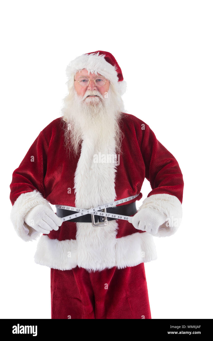 Santa Claus measures his belly on white background Stock Photo - Alamy