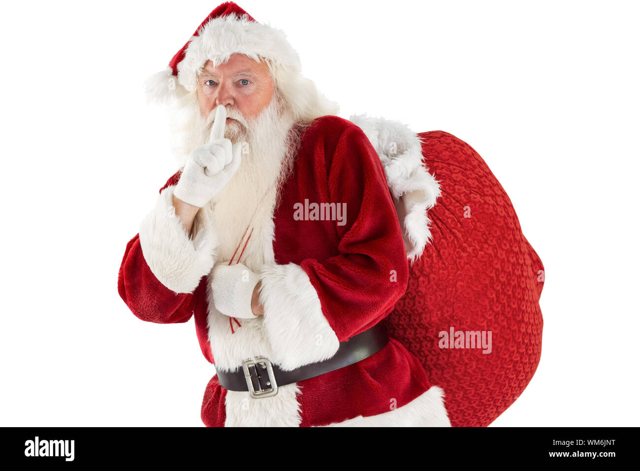 Santa asking for quiet with bag on white background Stock Photo - Alamy