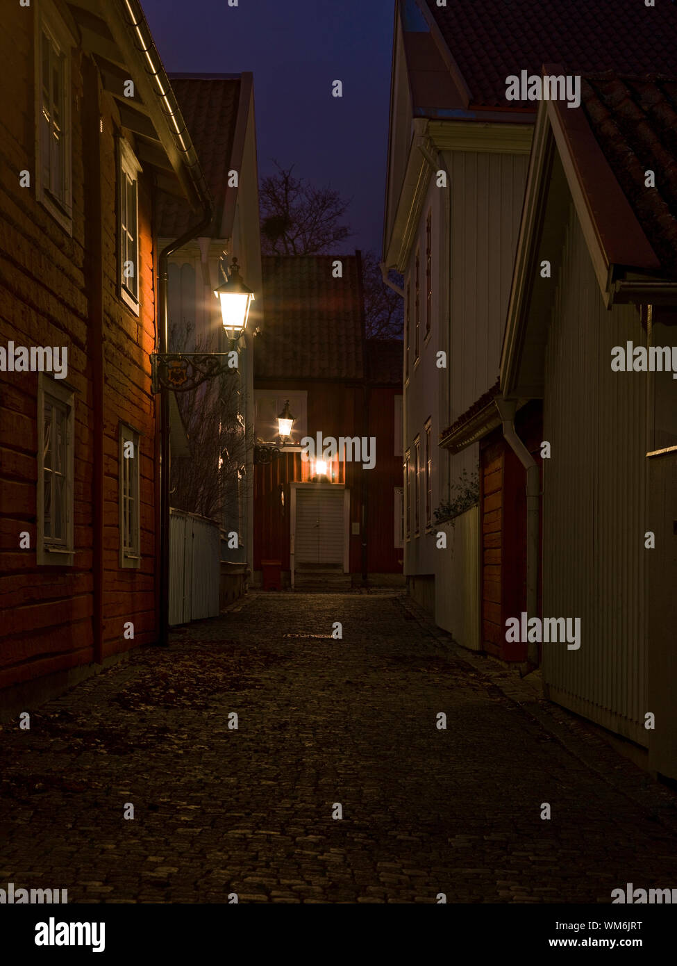 Cozy and colorful back alley at night time Stock Photo - Alamy