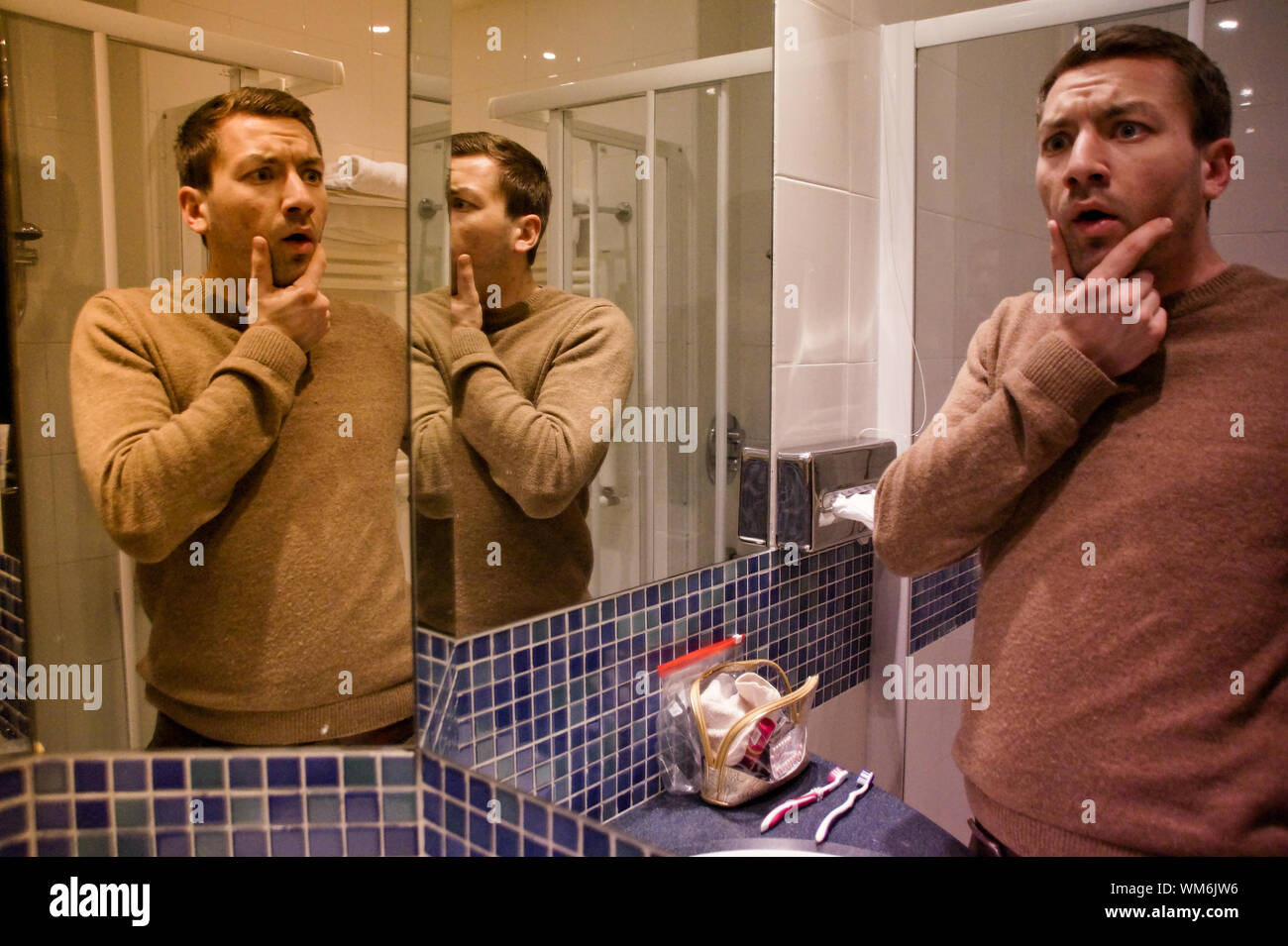 Shocked looking in mirror hi-res stock photography and images - Alamy