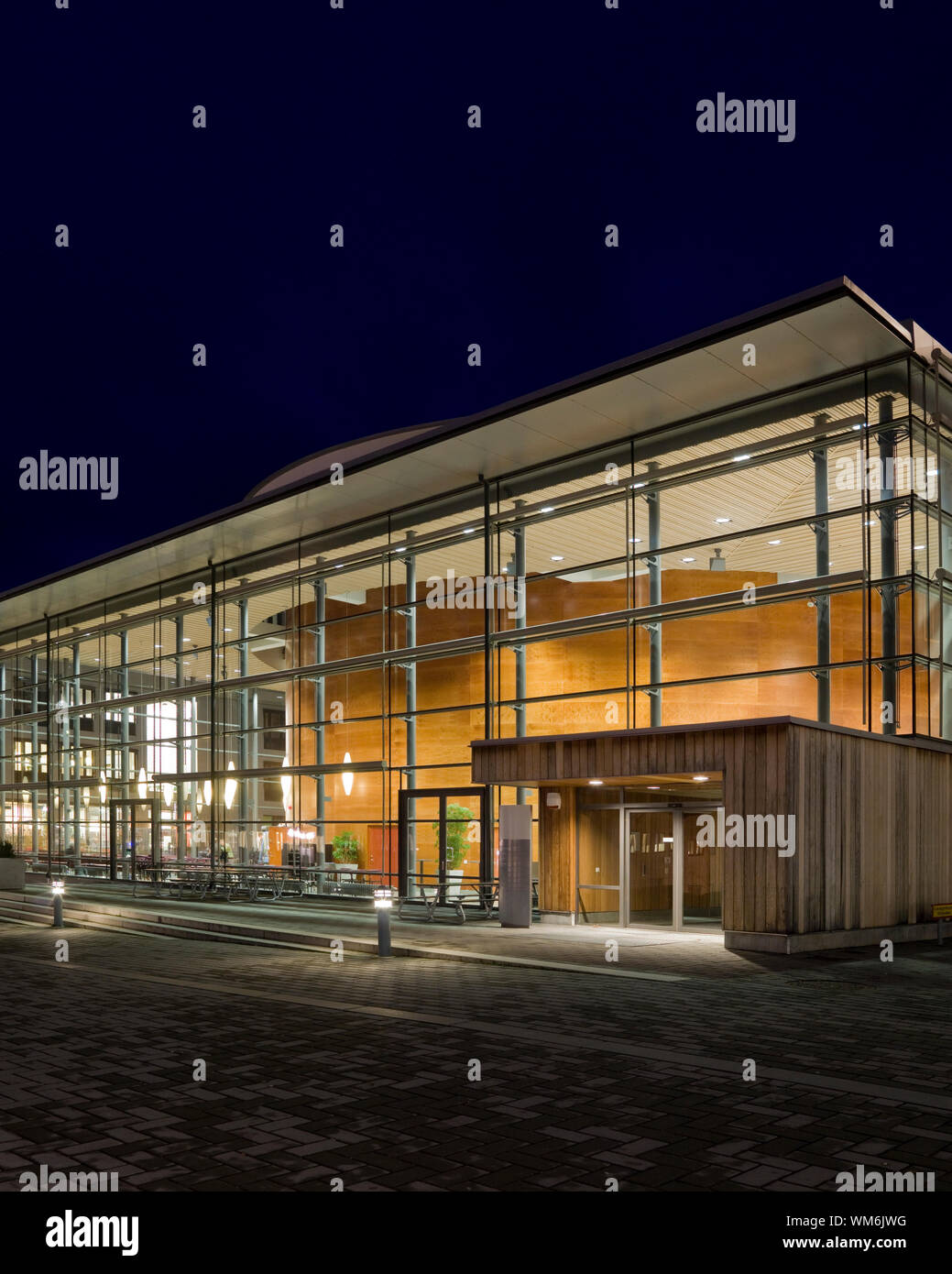 Modern glass building at night time with vivid colors Stock Photo - Alamy