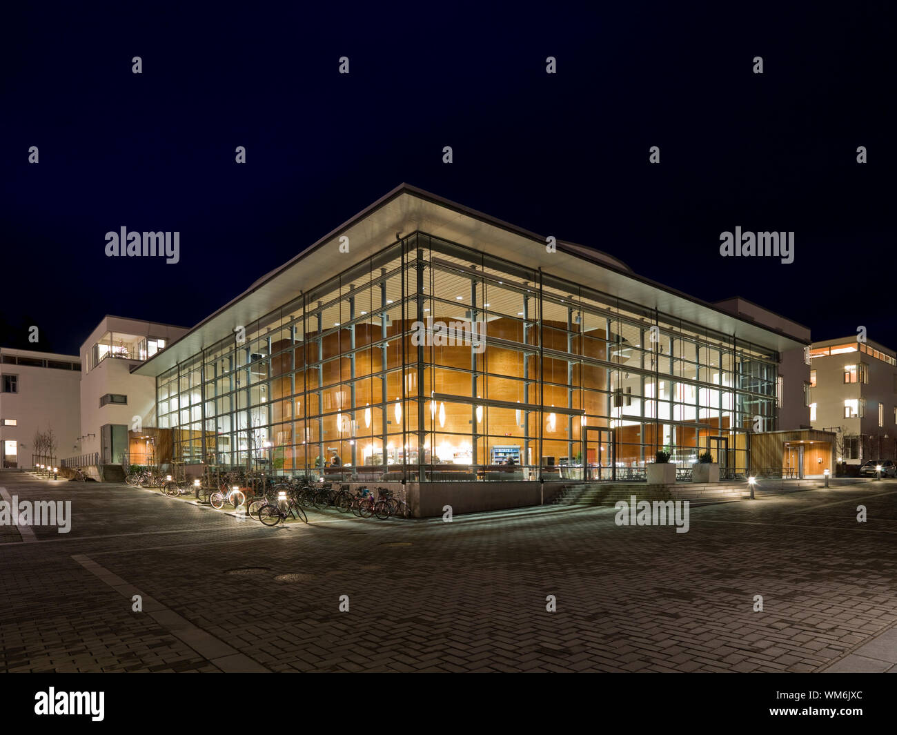 Modern glass building at night time with vivid colors Stock Photo - Alamy