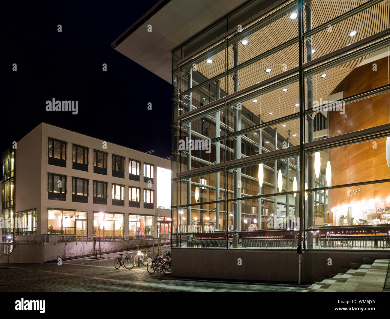 Modern glass building at night time with vivid colors Stock Photo - Alamy