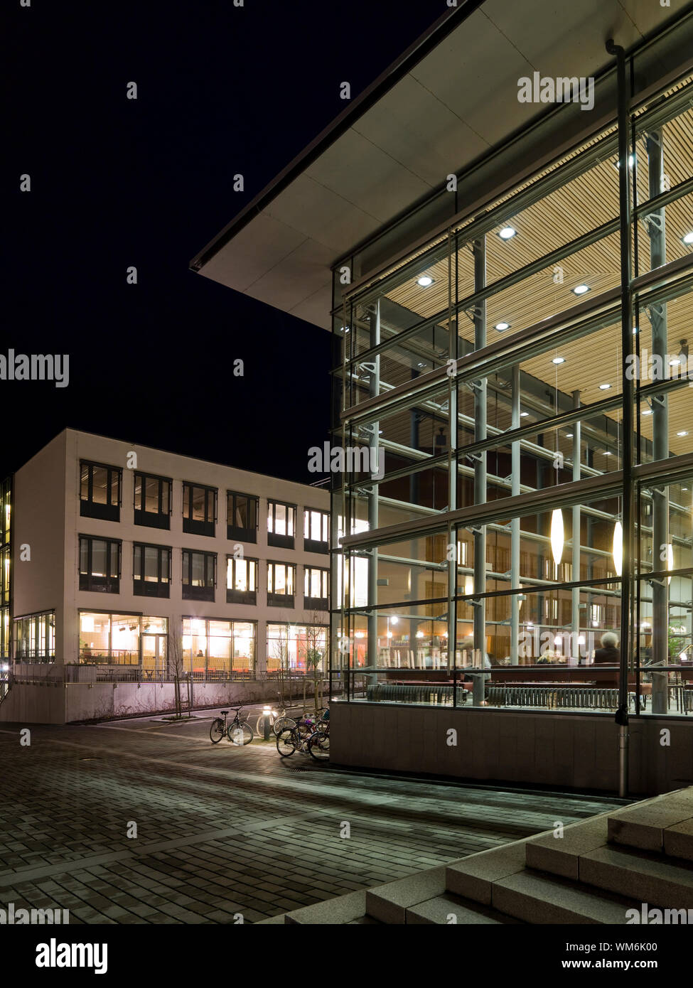 Modern glass building at night time with vivid colors Stock Photo - Alamy