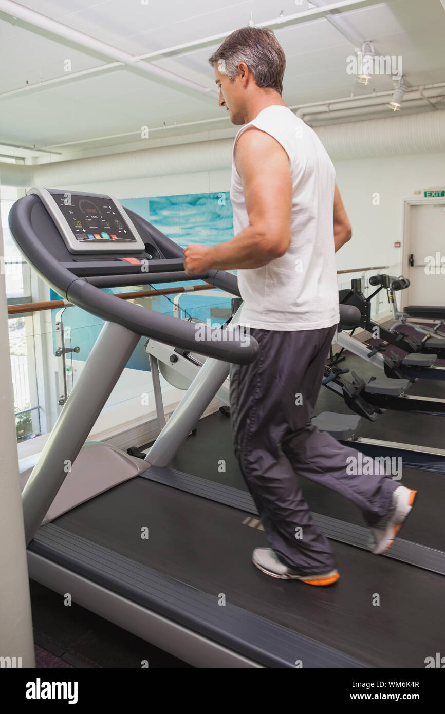 Fit man working out on treadmill at the gym Stock Photo - Alamy