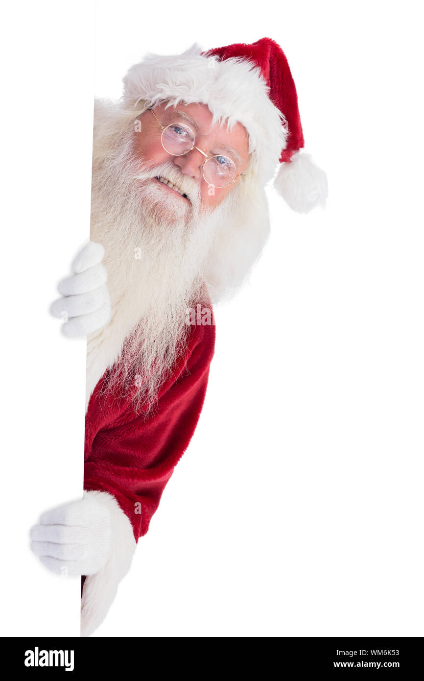 Santa looks out behind a wall on white background Stock Photo - Alamy