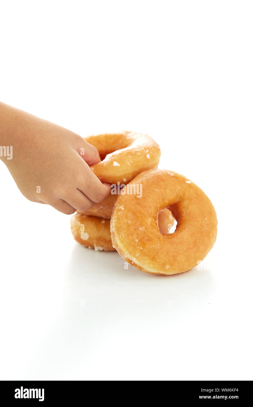 Cropped Hand Having Donut Against White Background Stock Photo - Alamy
