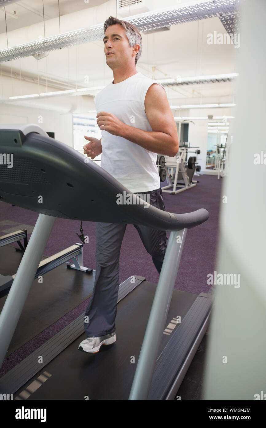 Fit man working out on treadmill at the gym Stock Photo - Alamy