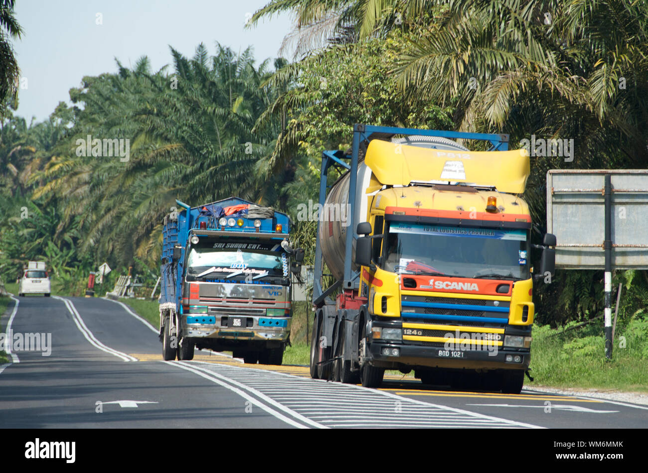 Trucks carrying palm oil circulate on a road in central Malaysia Stock ...
