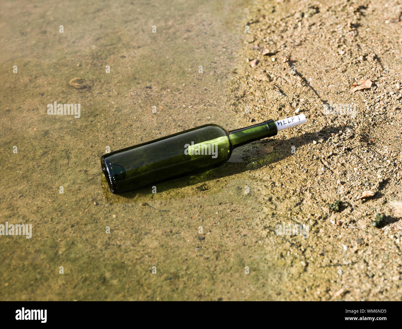 The word 'help' enclosed in a bottle Stock Photo - Alamy