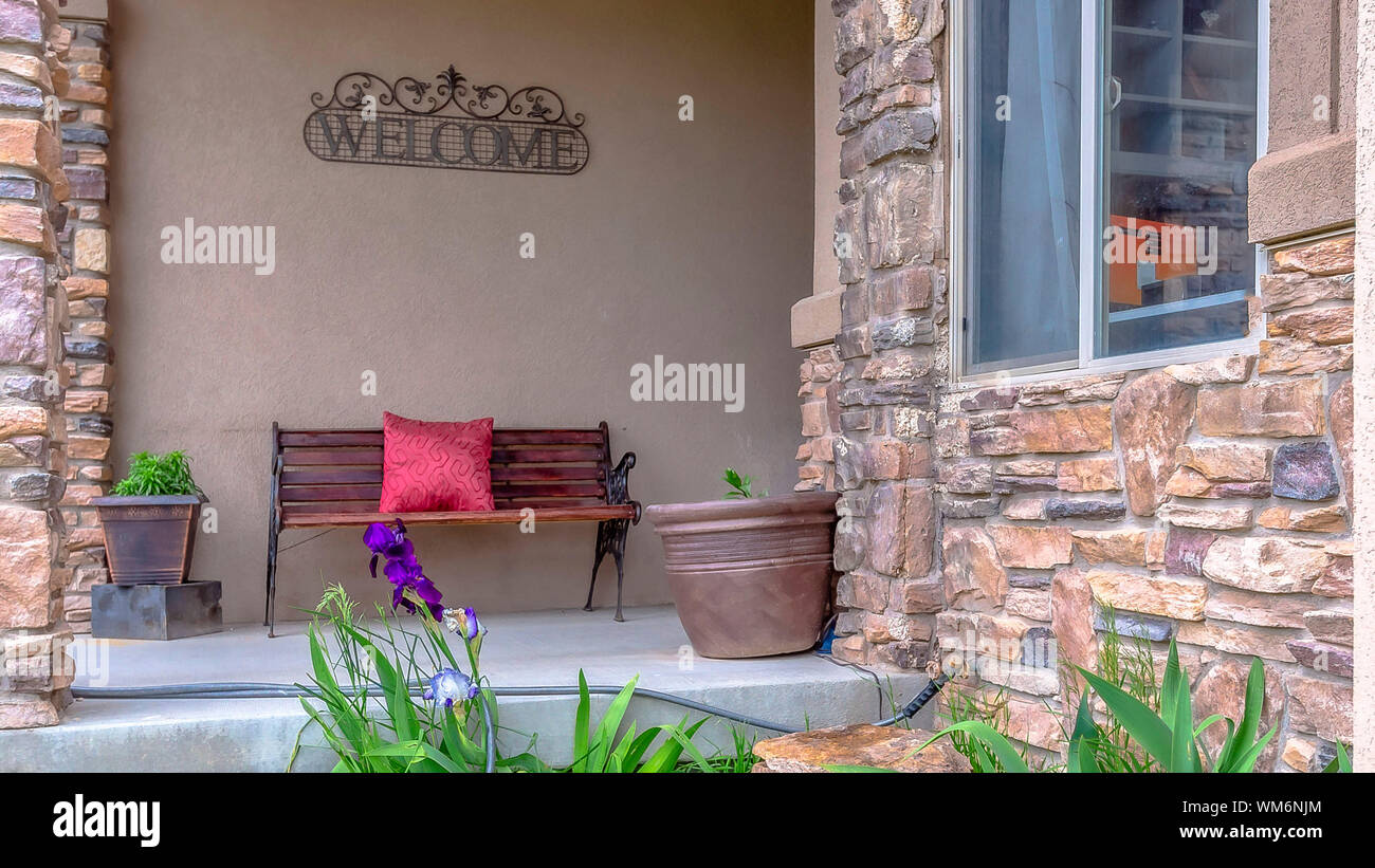 Panorama Small man made pond at the garden of a home with concrete and ...