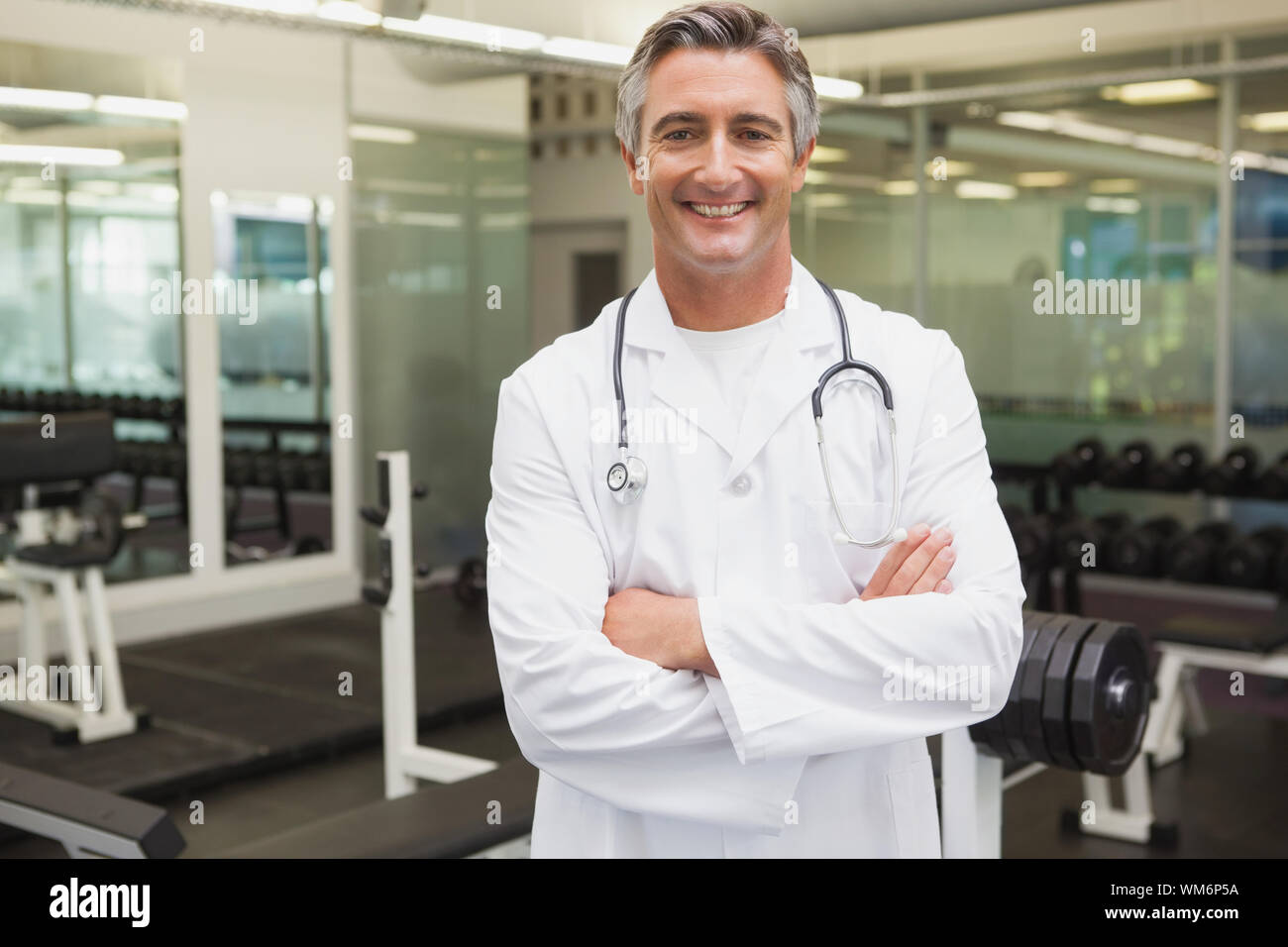 Confident doctor standing in weights room at the gym Stock Photo - Alamy