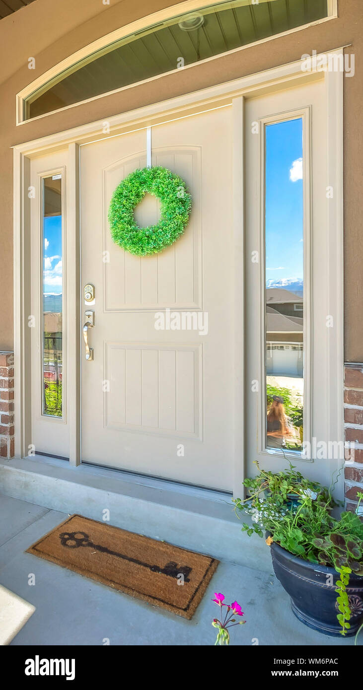 Vertical Front door with wreath transom window and sideligts at the ...
