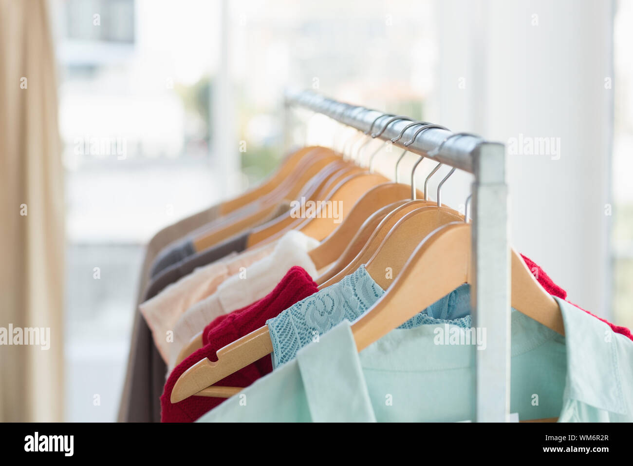 Close up of clothing rail at clothes store Stock Photo - Alamy
