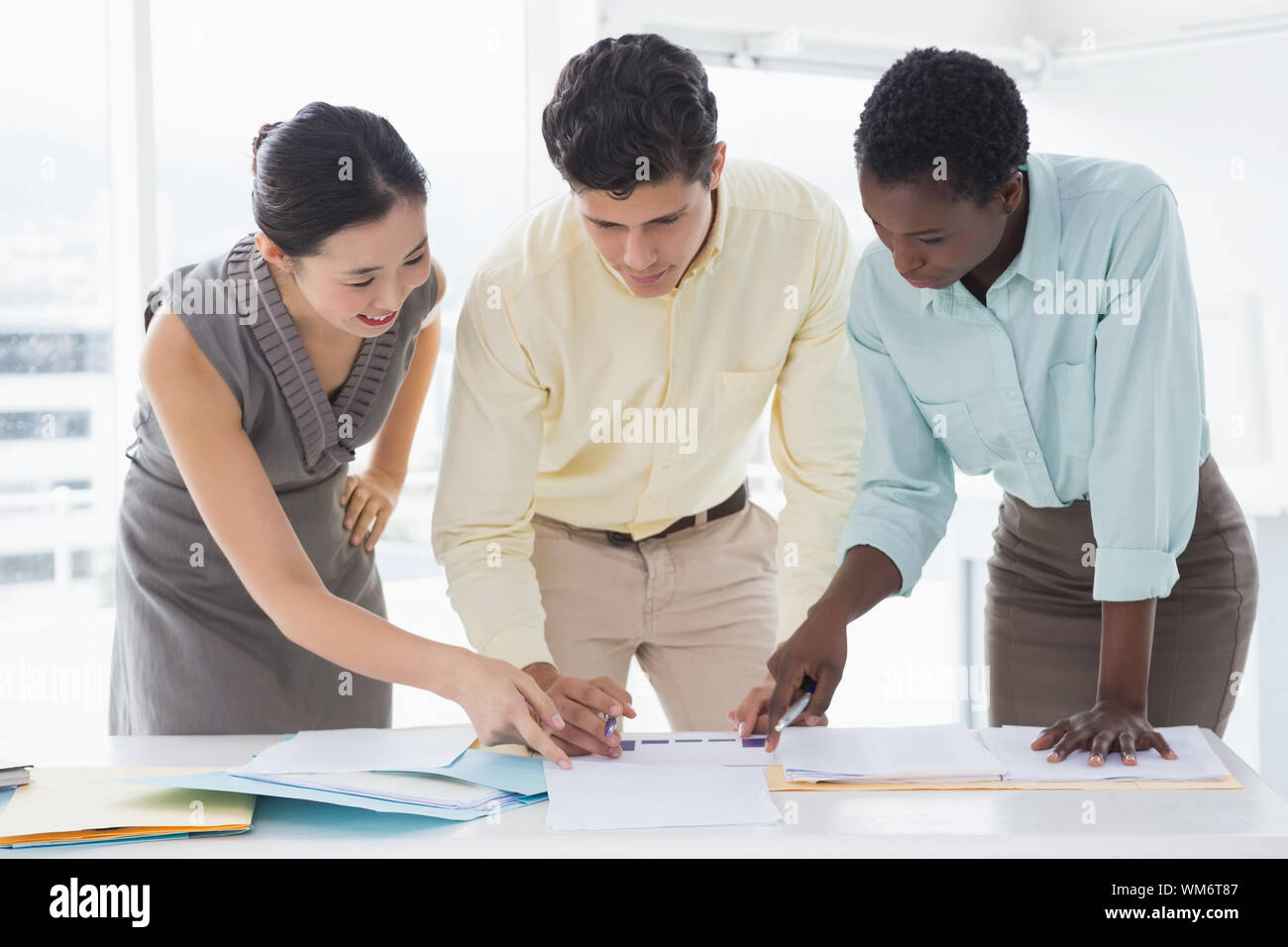 Business team working together at a meeting in creative office Stock ...
