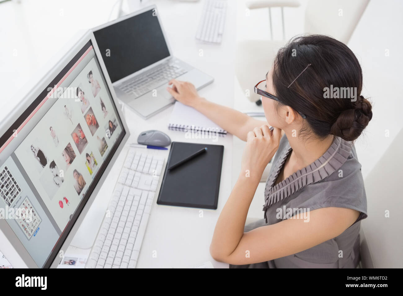Photo editor working at her desk in creative office Stock Photo - Alamy