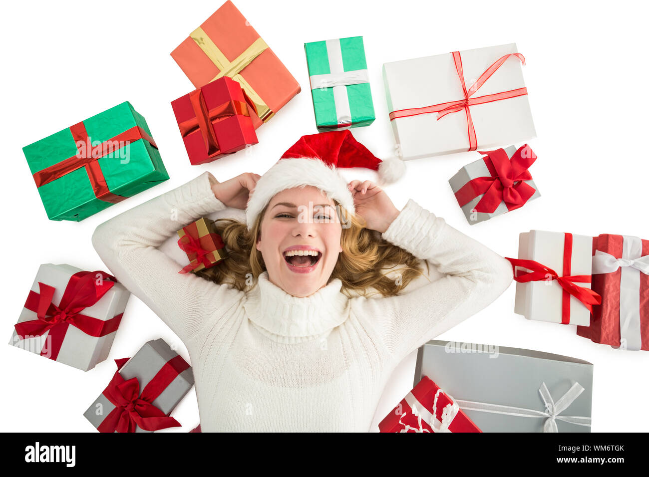 Woman laying on the floor with gifts around her on white background ...