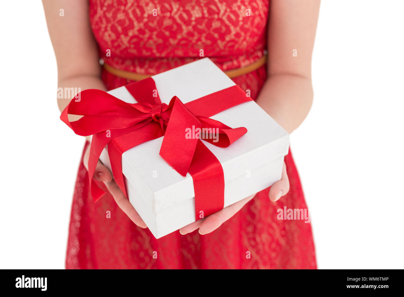 Pretty woman in red dress offering present on white background Stock ...