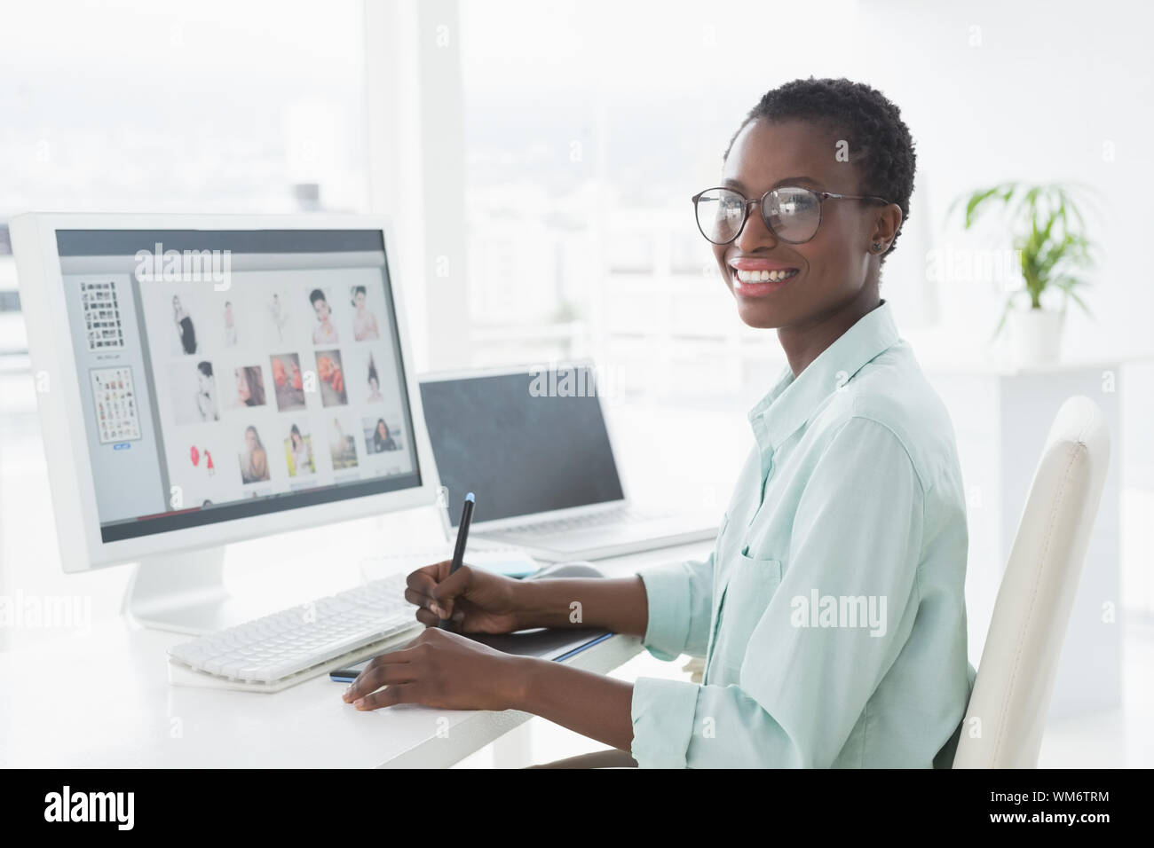 Photo editor working at her desk in creative office Stock Photo - Alamy
