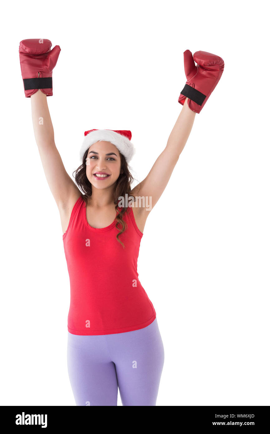 Festive brunette in boxing gloves cheering on white background Stock ...