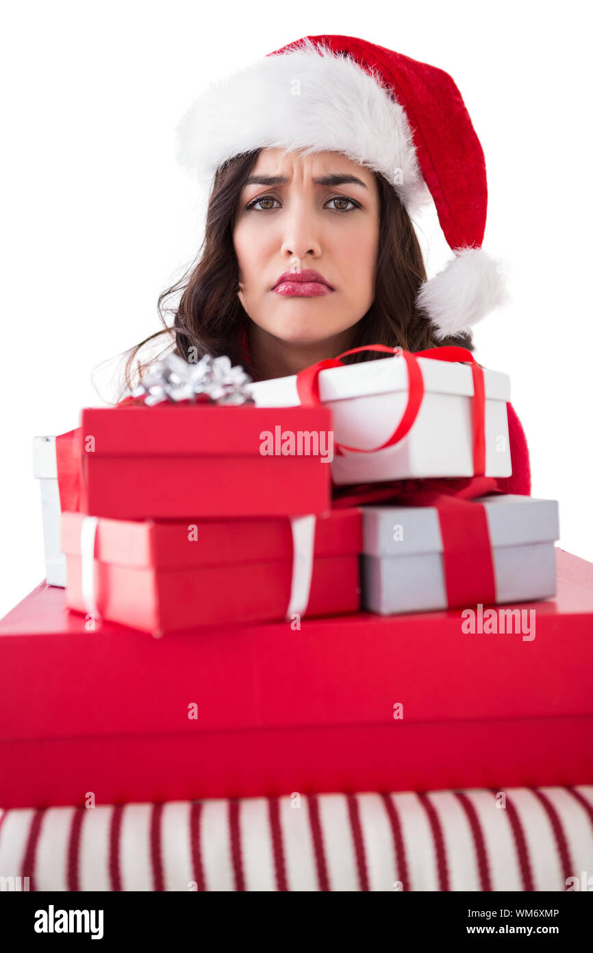 Confused brunette holding pile of gifts on white background Stock Photo ...