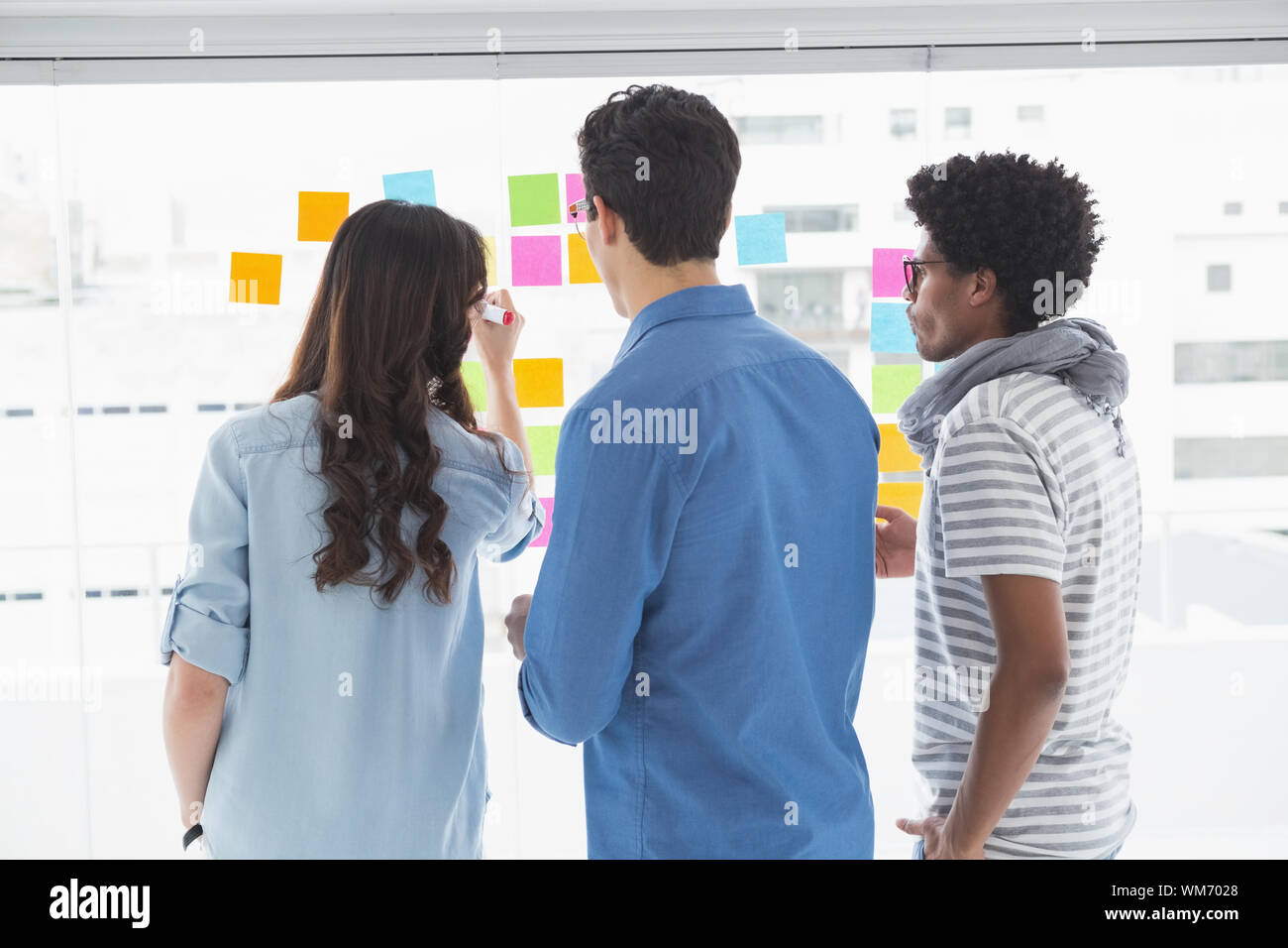 Young creative team brainstorming together in creative office Stock ...