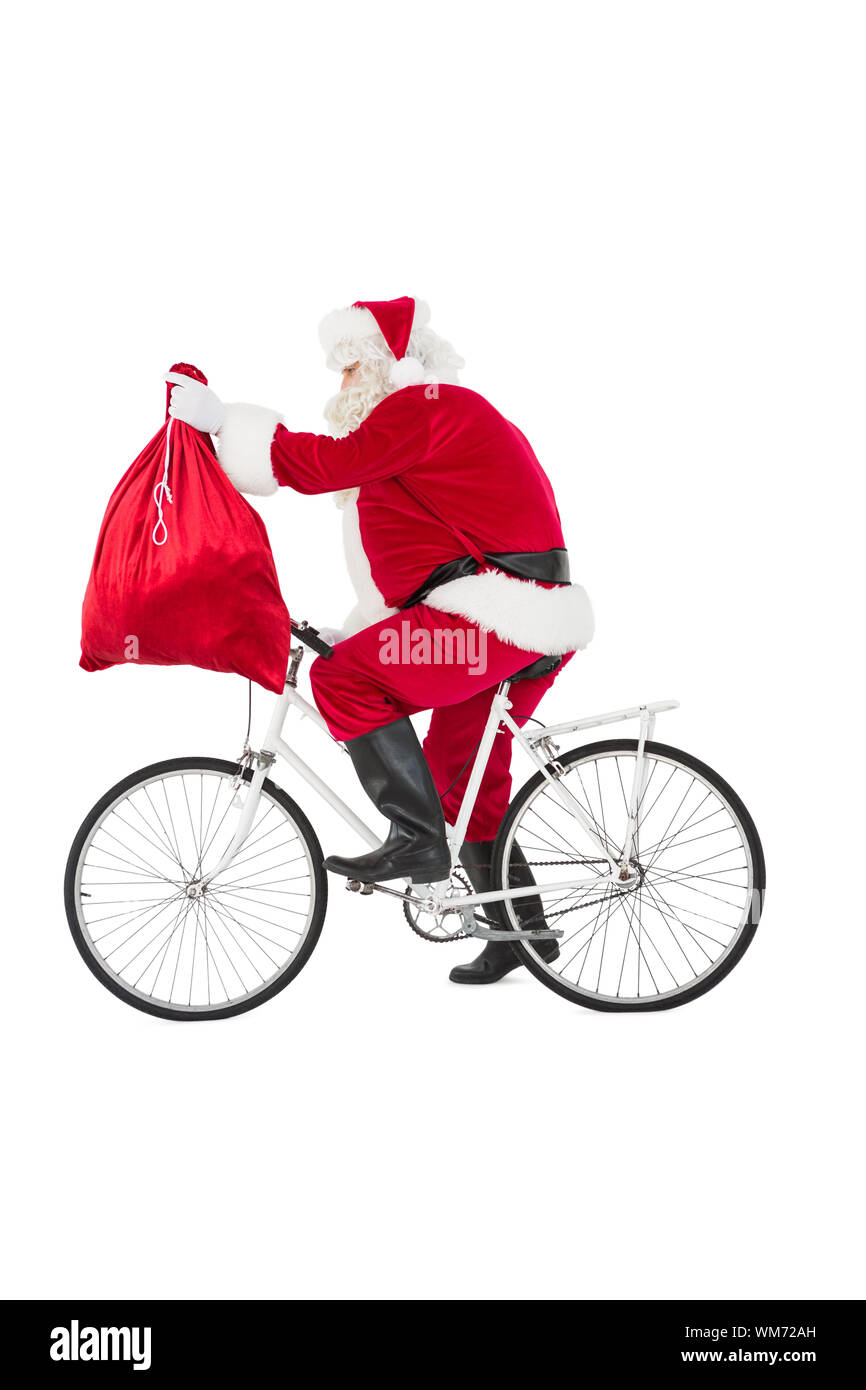 Santa cycling and holding his sack on white background Stock Photo - Alamy