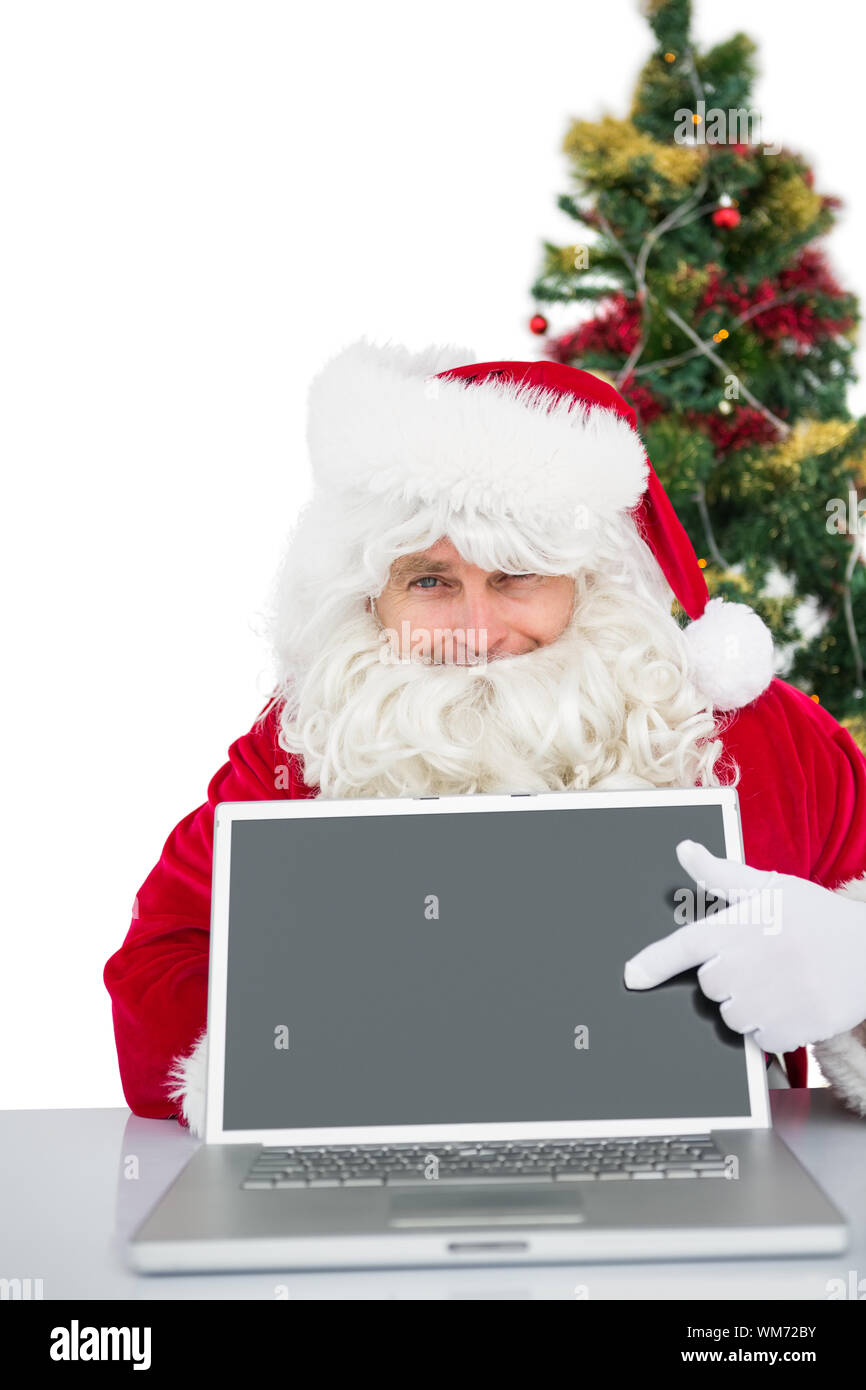 Santa claus showing his laptop on white background Stock Photo - Alamy