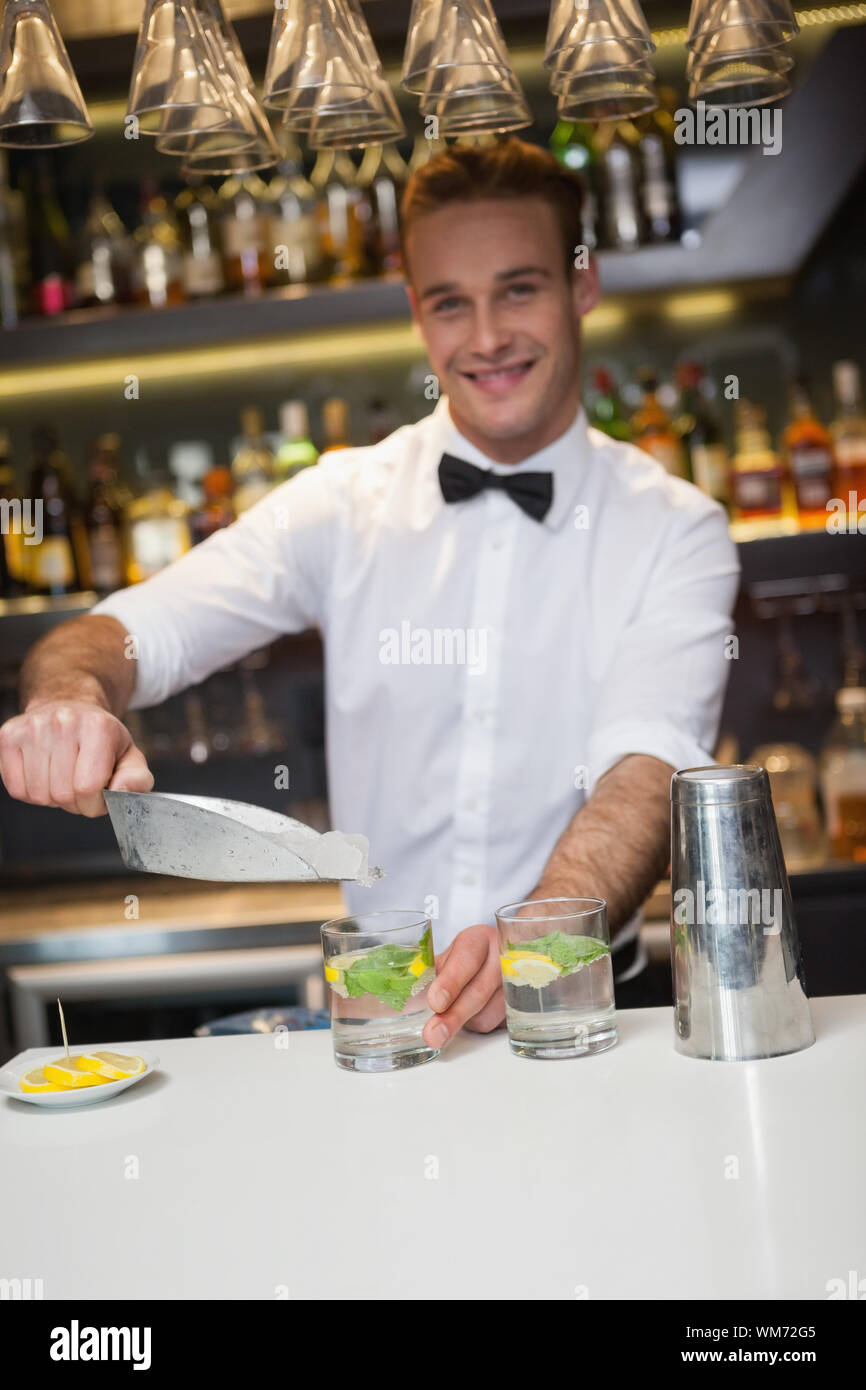 Happy bartender making a cocktail in a bar Stock Photo - Alamy