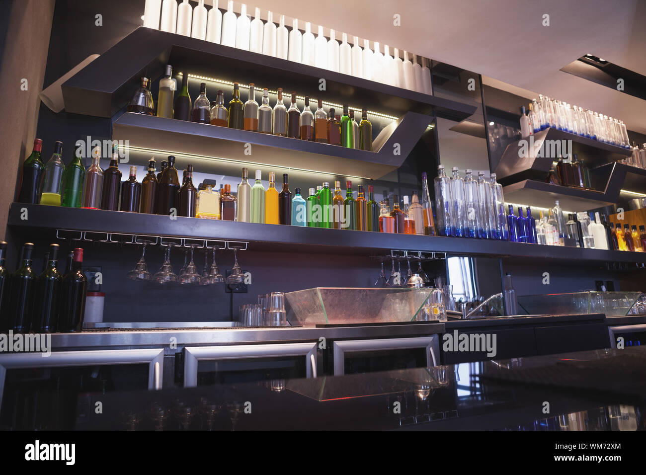 Close up on bar with bottle in a line at the nightclub Stock Photo - Alamy